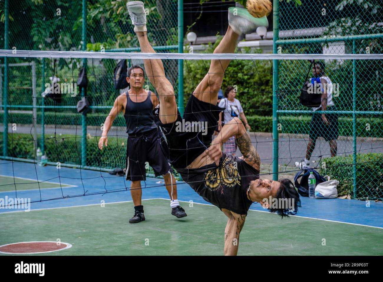 A Thai player of Sepak Takraw is seen performing an acrobatic figure ...