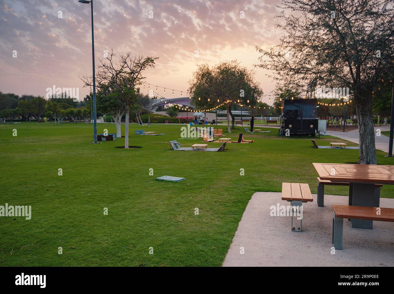 Large green evening park in the big city, Umm Al Emarat Park in Abu ...