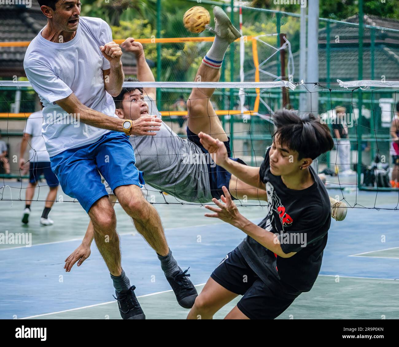 Bangkok, Thailand. 25th June, 2023. Local residents and a foreigner are seen playing Sepak ...