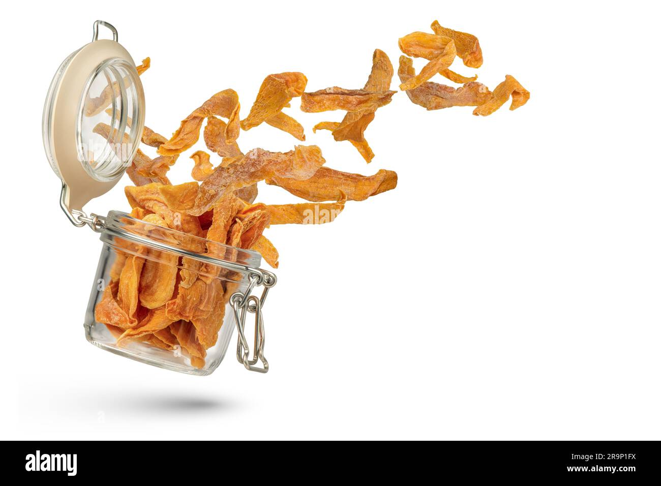 Dried mango in a glass jar on a white isolated background. Dried mango ...