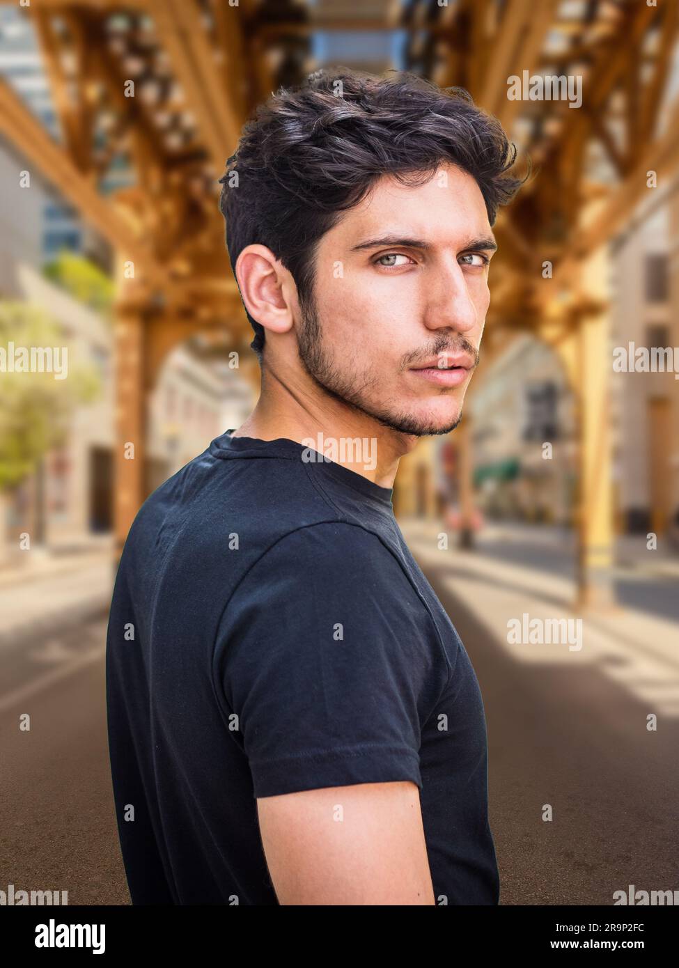 Head And Shoulder Shot Of One Handsome Young Man In Urban Setting Stock