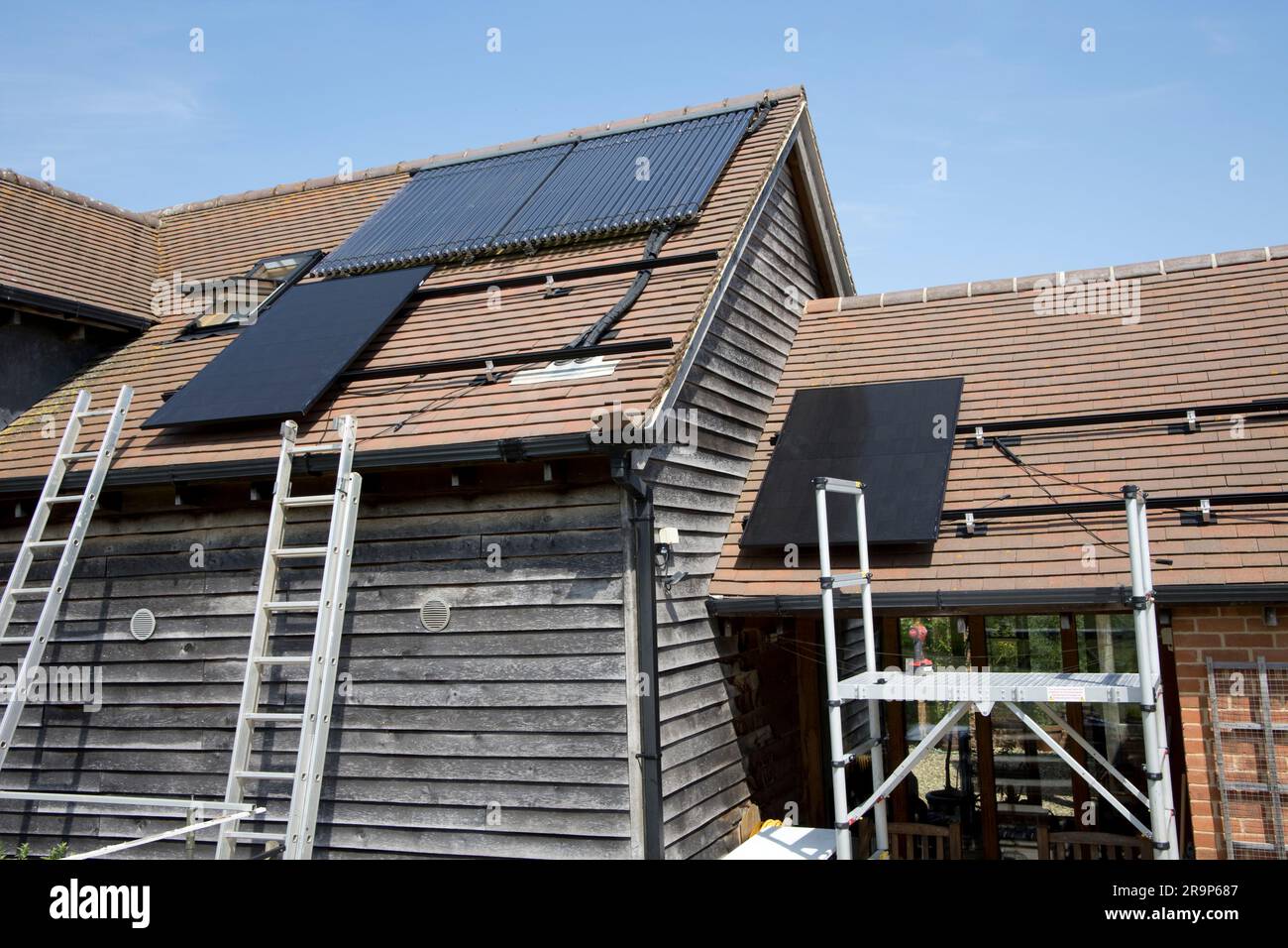 Installing black 410 Perlite panels on tiled roof Colemans Hill Farm ...