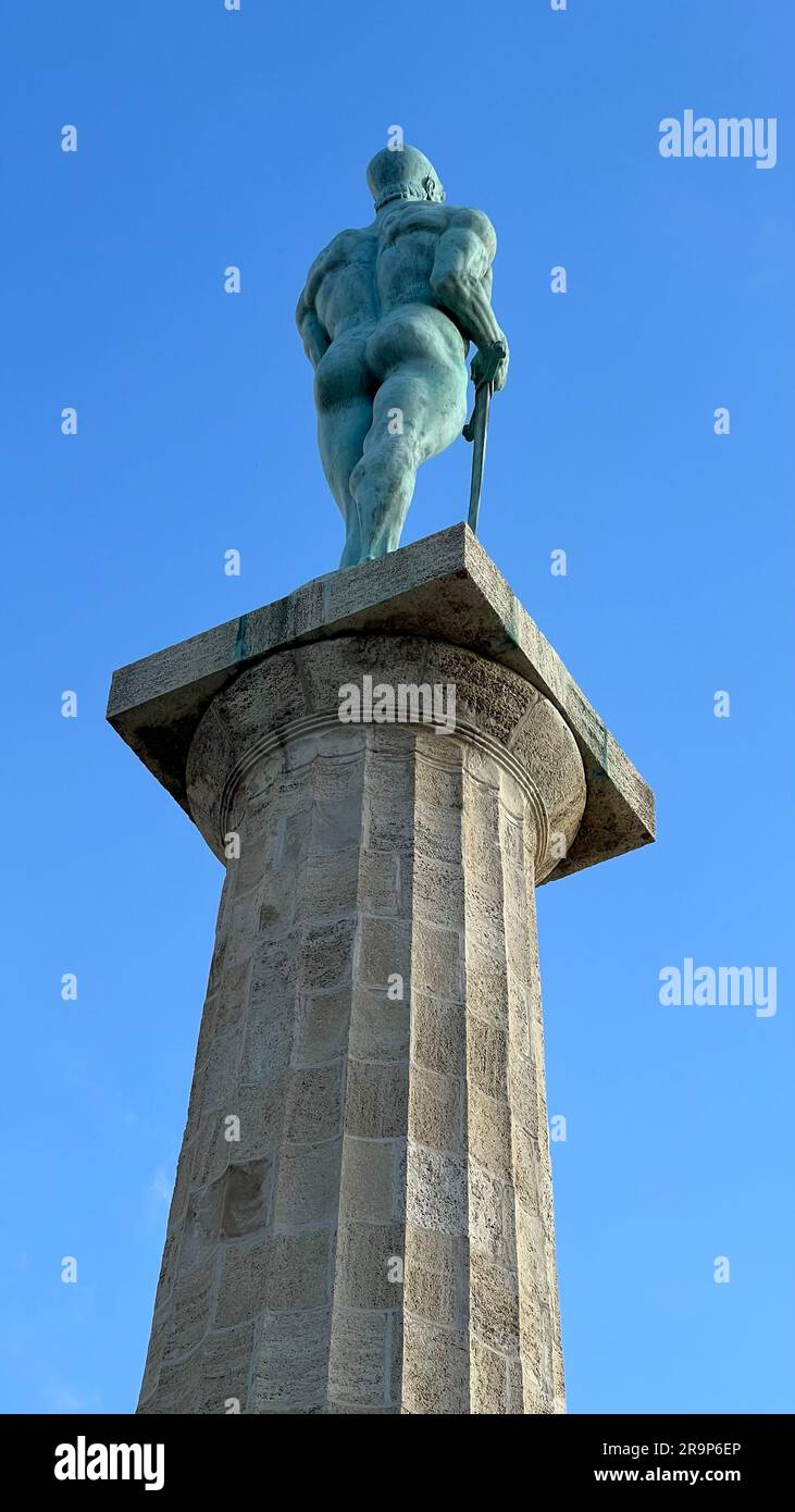 A vertical low angle shot of The Victor statue under a blue sky in ...