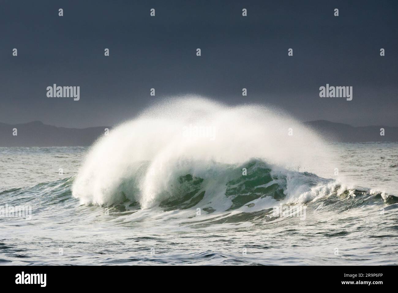 Wave breaks in winter storm in open sea off north coast of Ireland ...