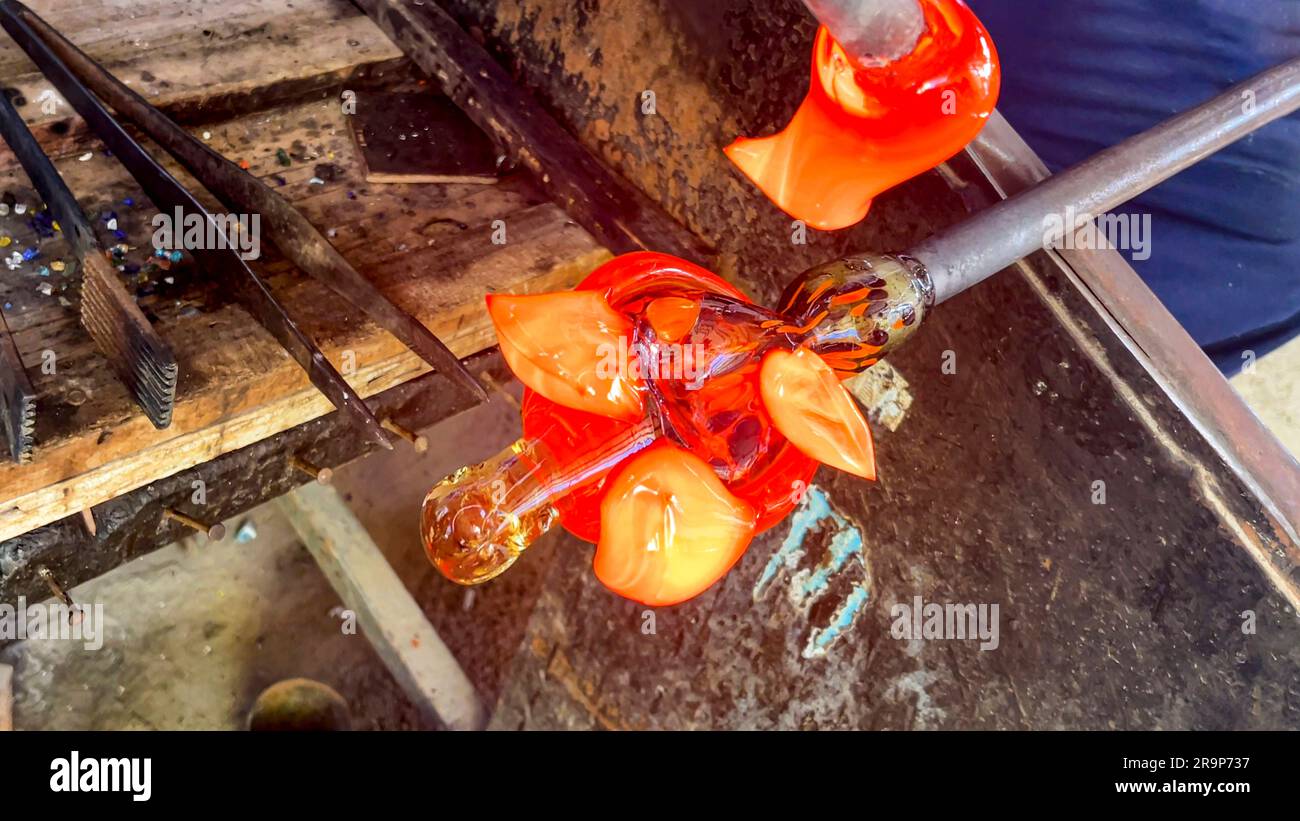 Craftsman making a glass figure using the traditional technique of ...