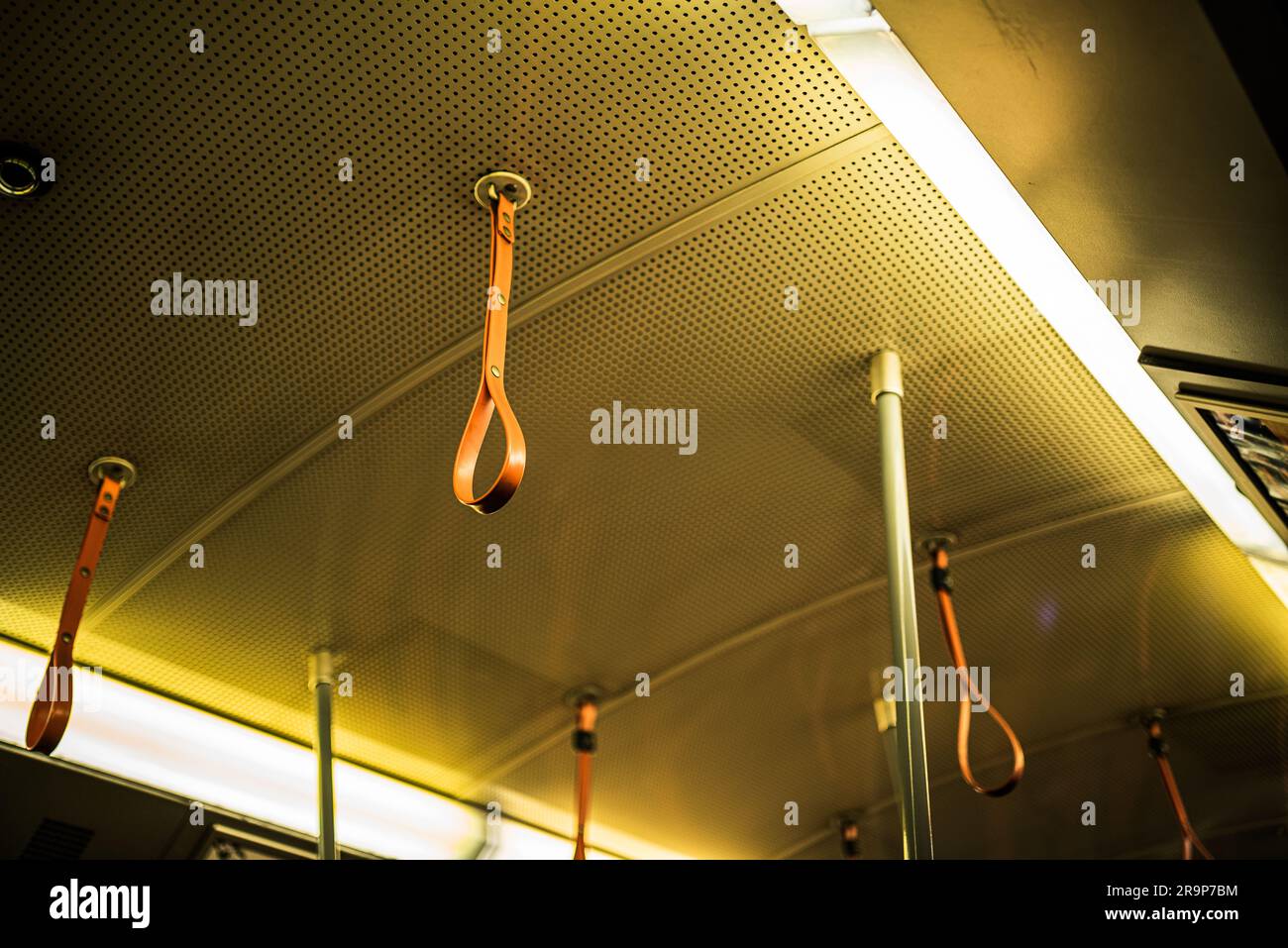 Yellow handles in an underground train in Vienna Stock Photo - Alamy