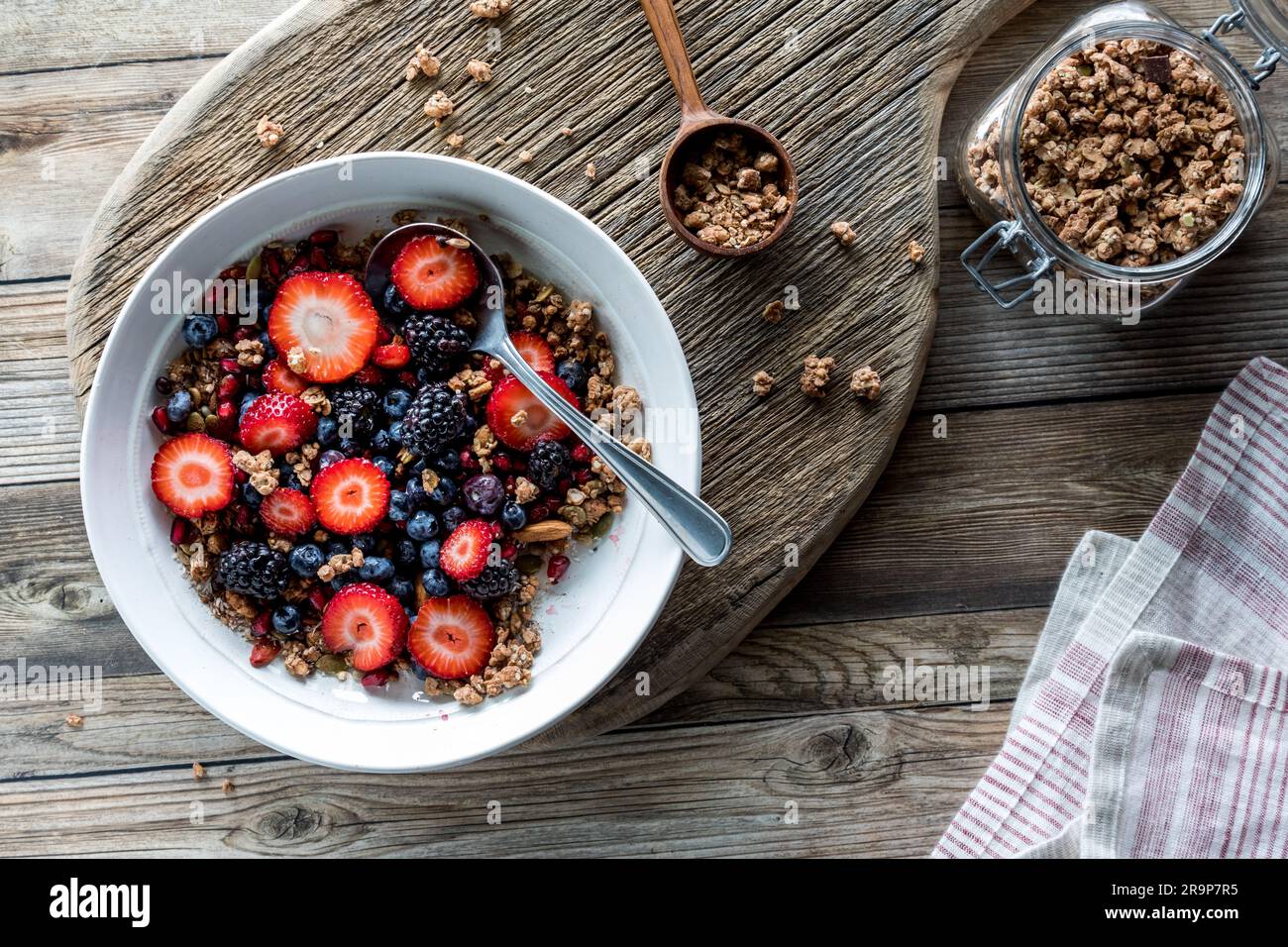 Topped down view of a healthy mixed berry and granola cluster breakfast ...