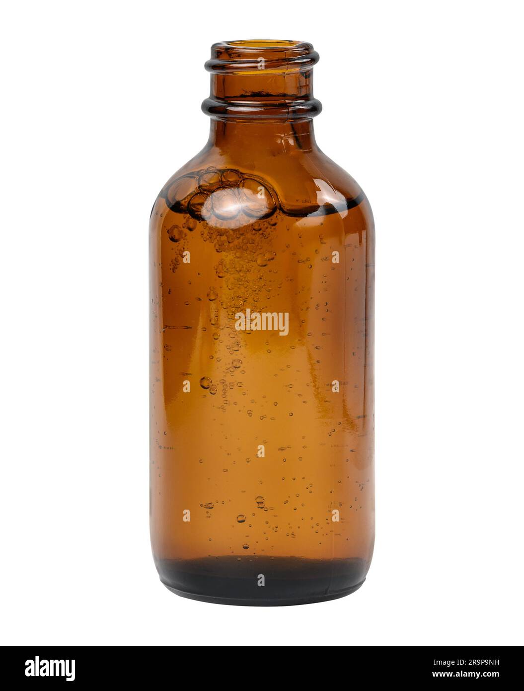 Open brown glass bottle with liquid on a white isolated background ...