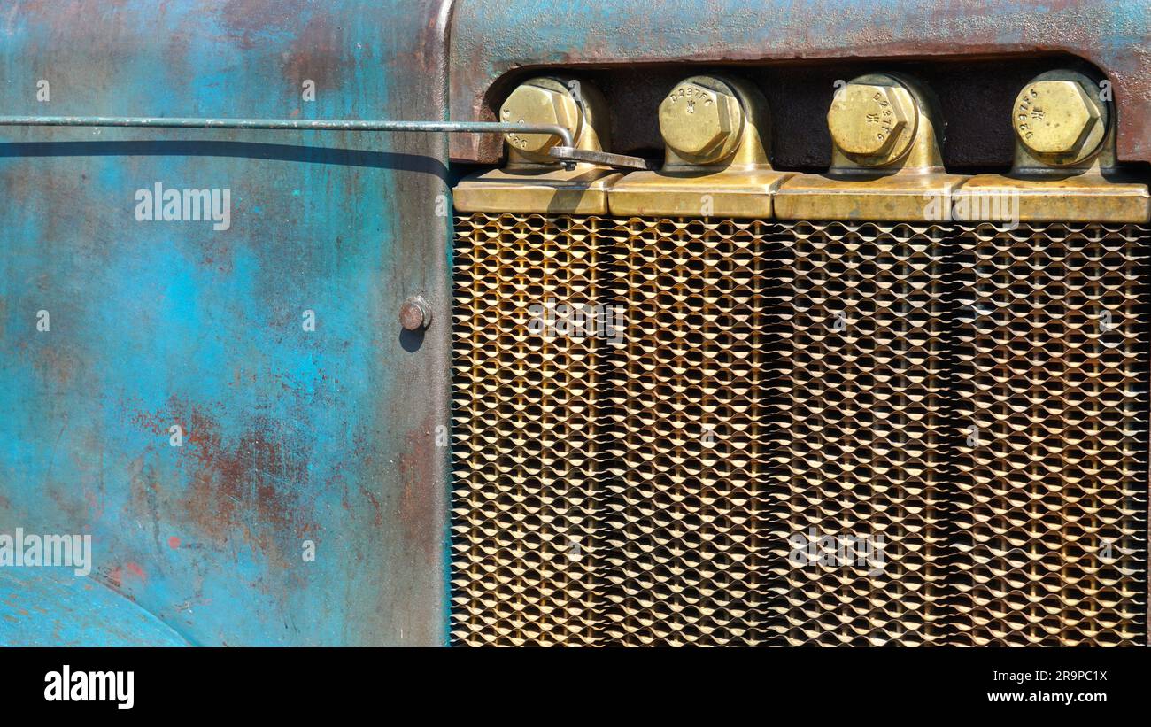 Closeup of a part of a well-maintained oldtimer tractor in blue and ...