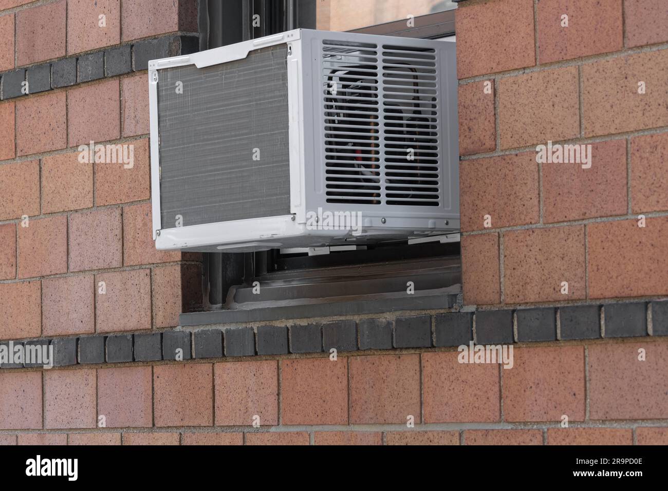 exterior view of air conditioning window unit extruding from the window ...