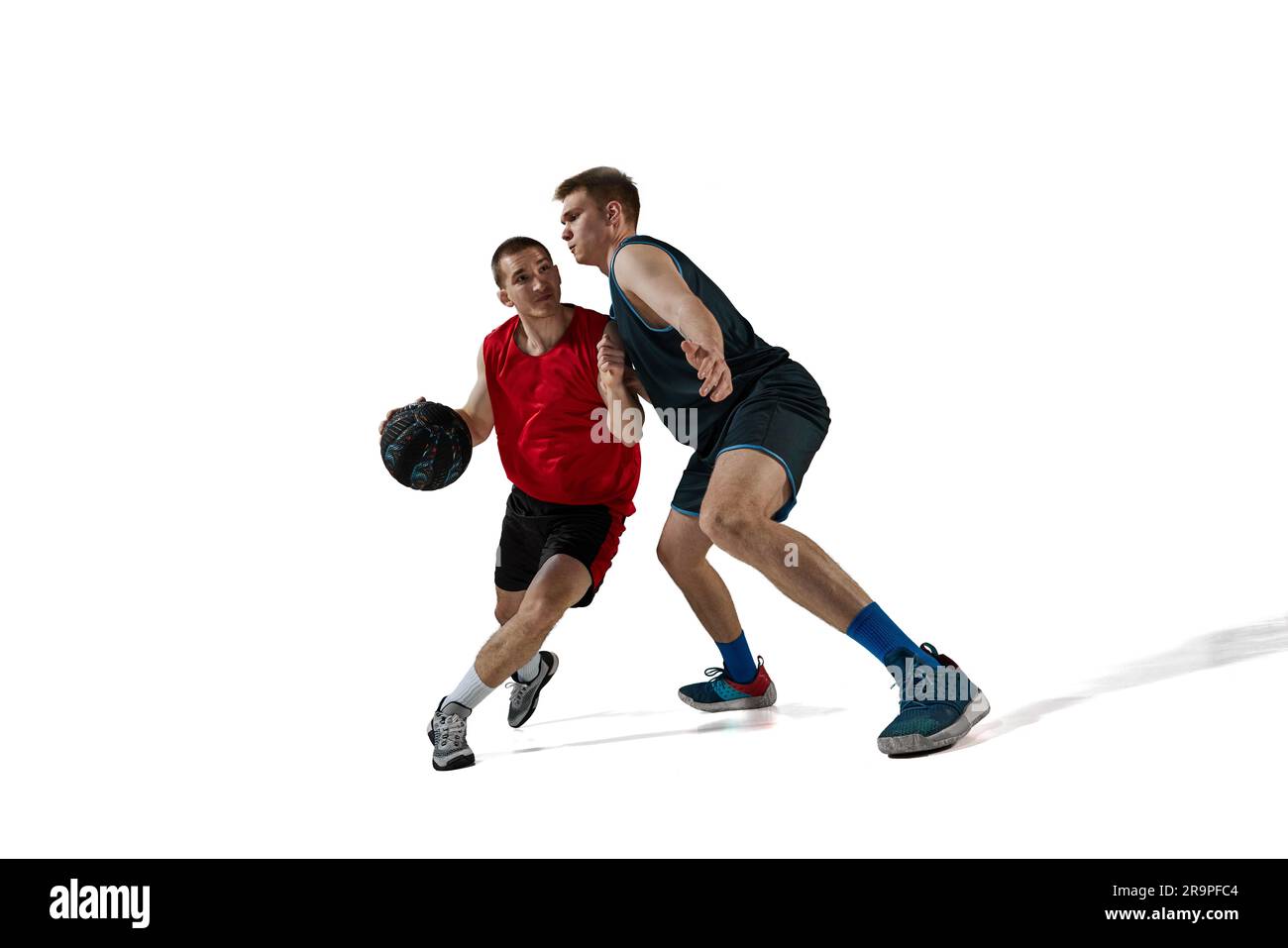 Two professional basketball players in motion during game, playing with ...