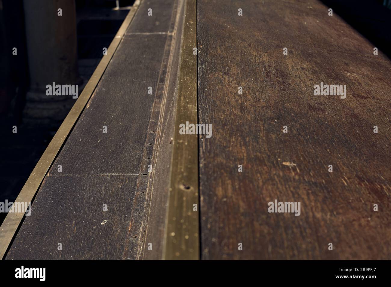 Wooden plank with a metallic border lit by the sun seen up close Stock ...