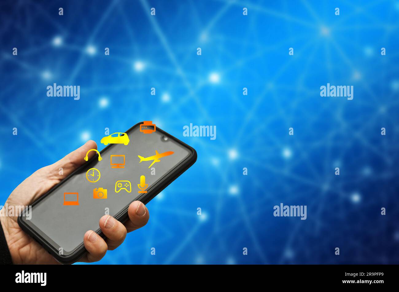 holding a smartphone with icon of connected tools and machines, IoT ...