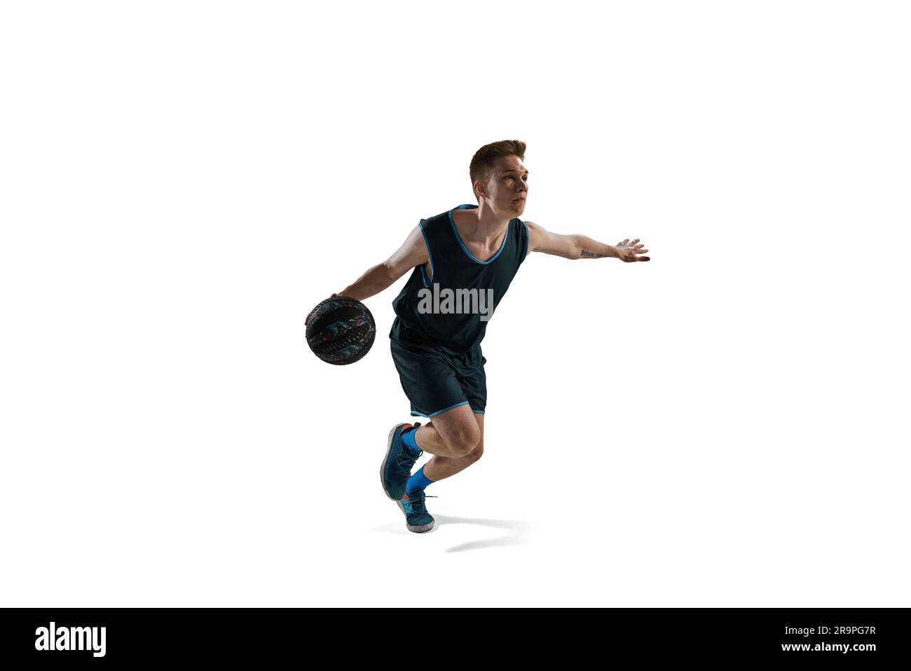Dynamic image of young man, athlete running with ball, playing ...