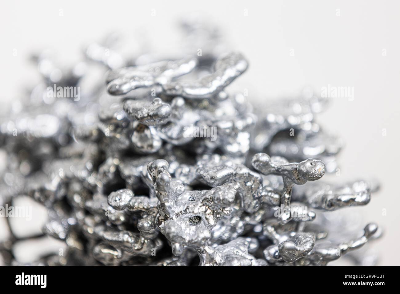 A closeup of a metal ant hill inside sculpture on a white background ...