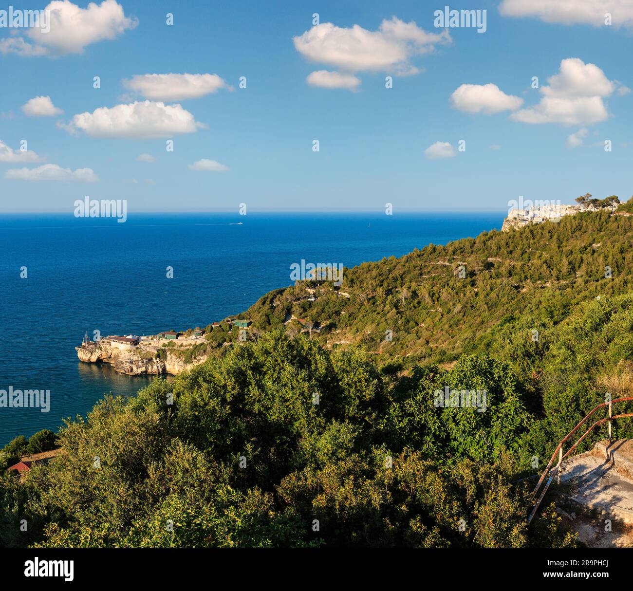 Summer sea perched Peschici town and cape Trabucco di Monte Pucci view ...