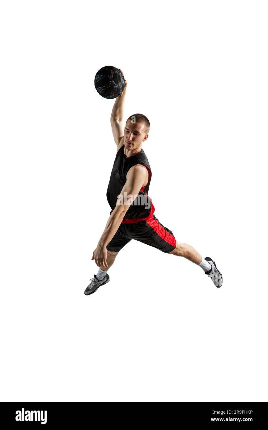 Slam dunk. Full-length dynamic image of young man, basketball player in ...