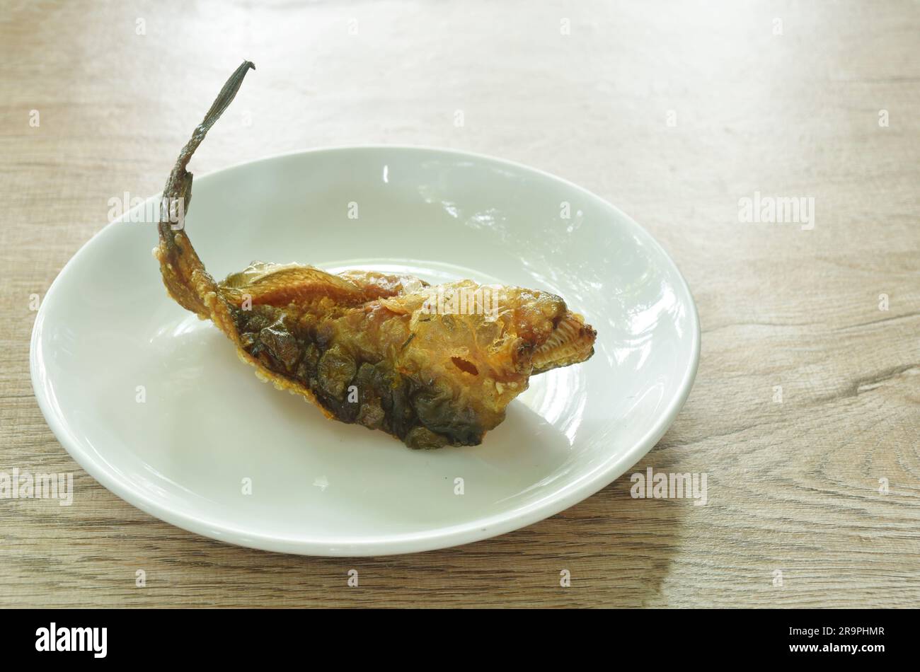 deep fried snake skin catfish arranging on dish Stock Photo - Alamy