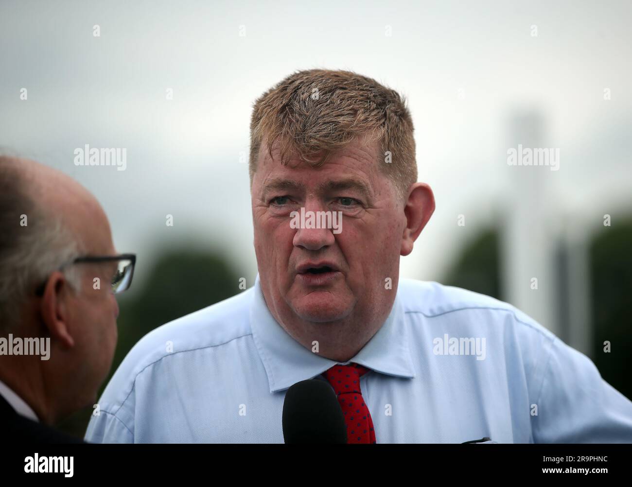 Trainer John Hanlon reacts after jockey Paddy Hanlon wins the Richard ...
