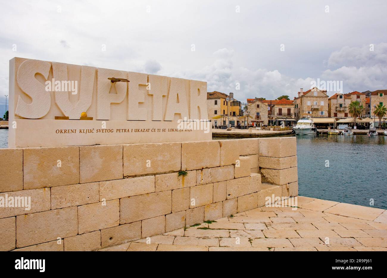The harbour sign and ferry in Supetar port, Brac Island, Croatia. The ...