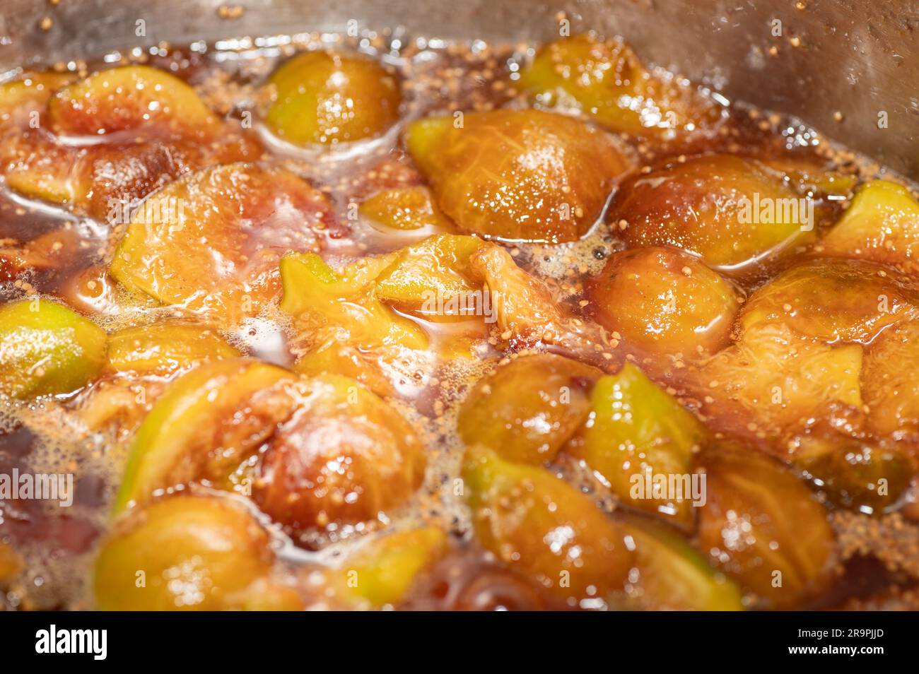 A harvest of figs boiling in a pot to be made into fig preserves Stock ...