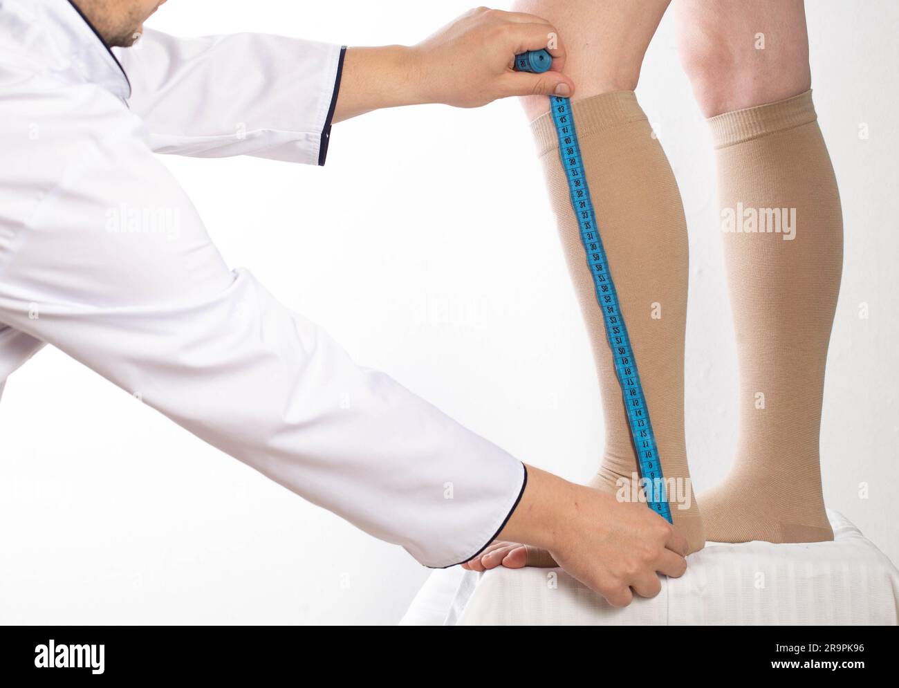 Doctor phlebologist - a vascular surgeon selects the size of the ...