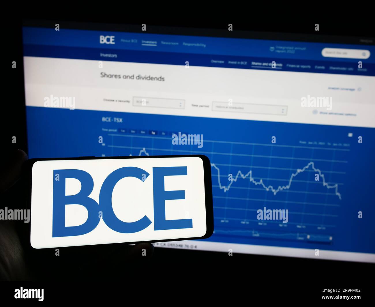 Person holding mobile phone with logo of Canadian telecommunications ...