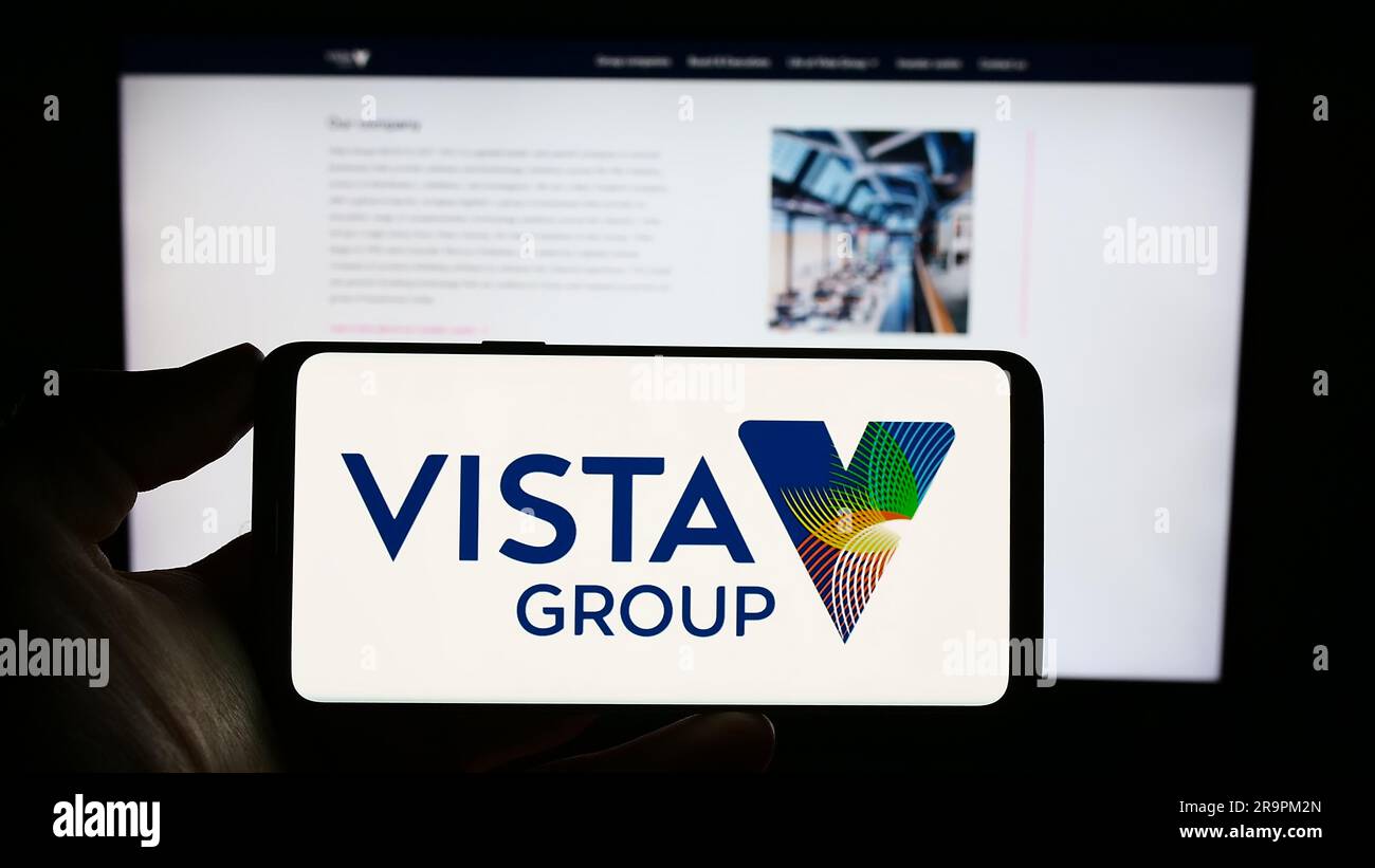 Person holding mobile phone with logo of company Vista Group ...