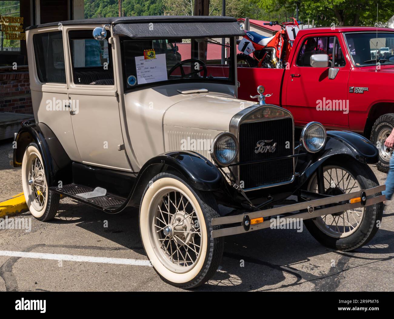 A tan 1927 Ford Model T coupe on display at a car show in Tidioute ...