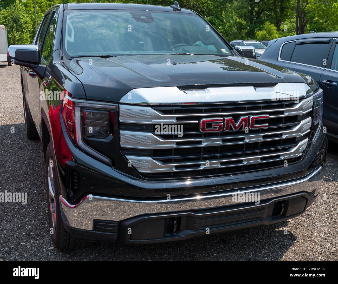 A used, black GMC four door pick up truck for sale at a dealership in ...