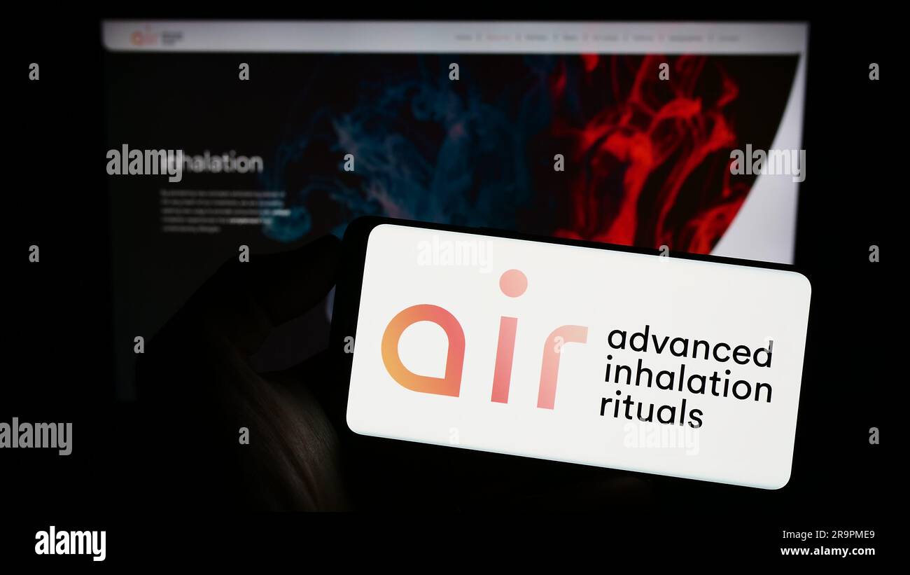 Person holding mobile phone with logo of company AIR Limited (Advanced ...