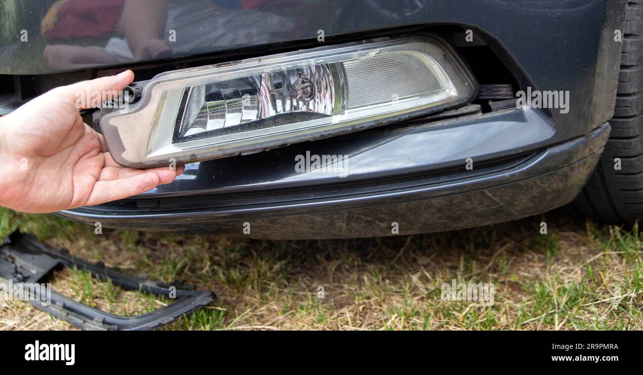 Disassembling and removing the fog lamp from a car to replace a burnt ...