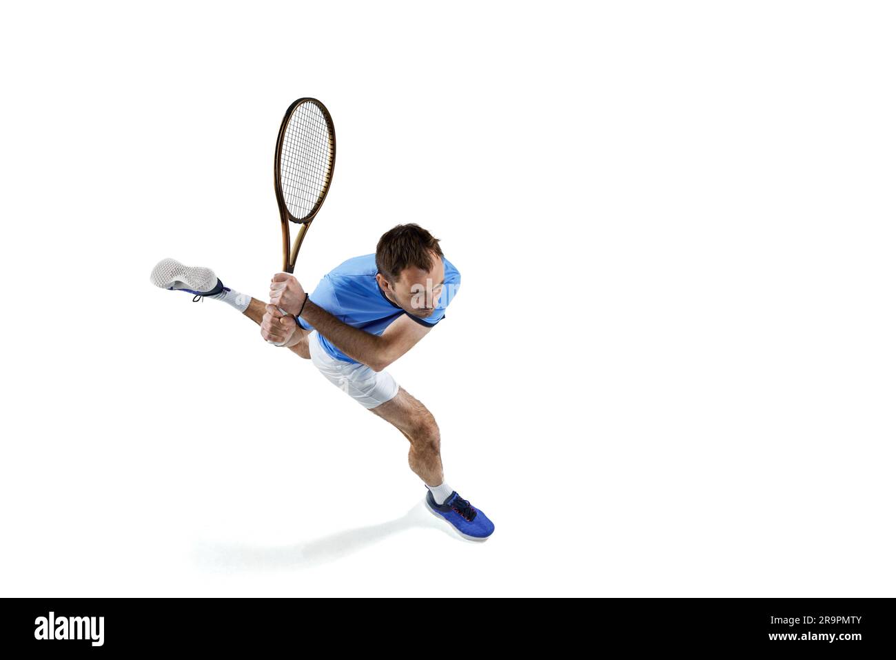 Top vie image of man in motion, playing tennis, running with racket ...