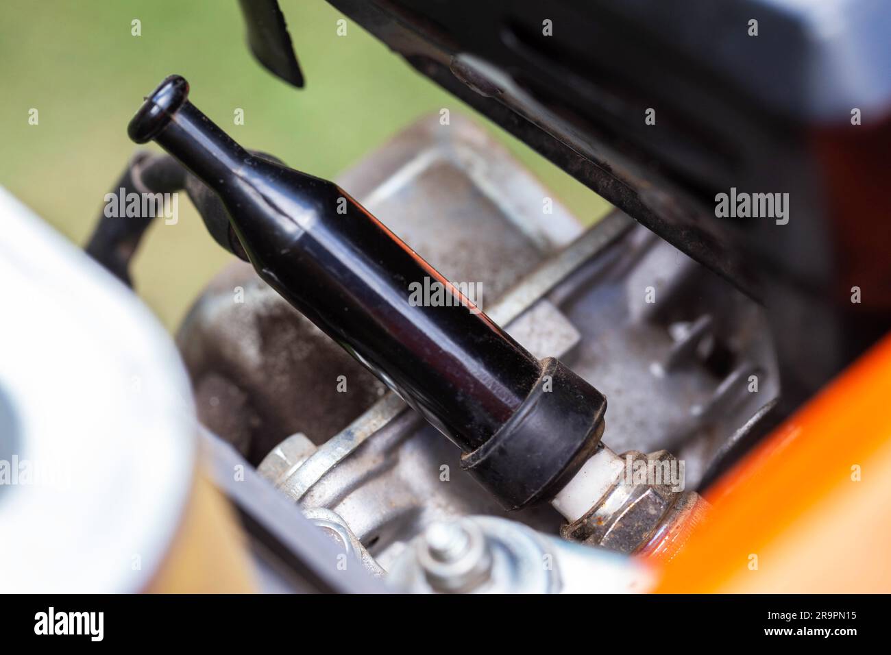 Spark plug in the engine cylinder of a walk-behind tractor. Maintenance ...