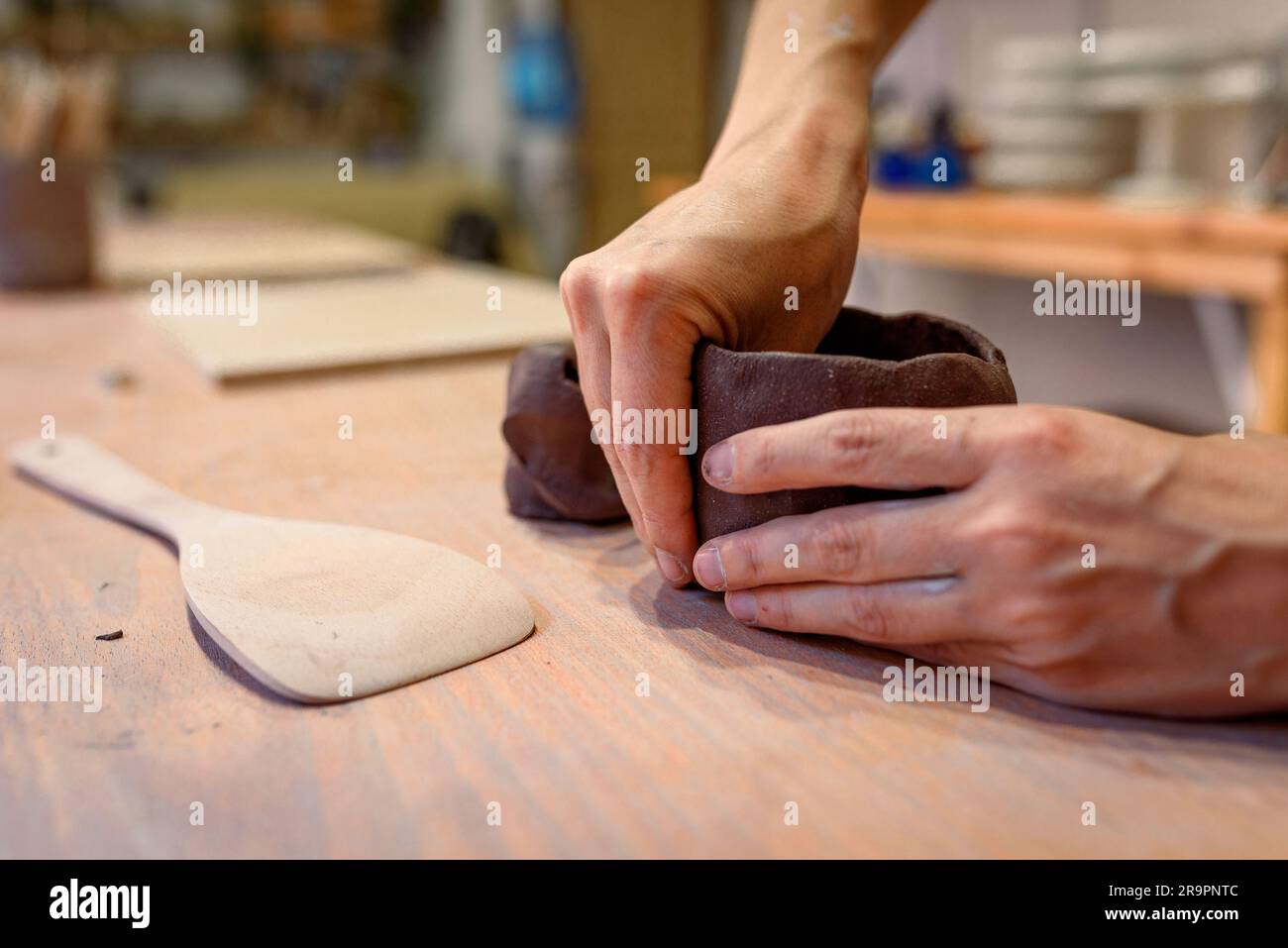 Close up of potter hands working with clay and ceramic tools, craftsman ...