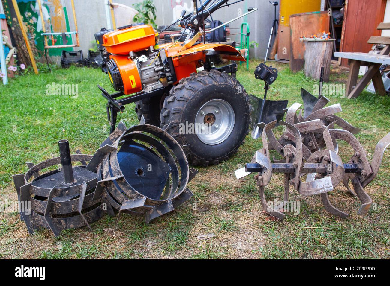 Agricultural walk-behind tractor with a set of attachments, hiller ...