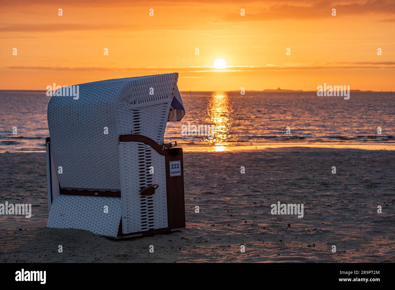 A beach chair on the beach at sunset Stock Photo - Alamy