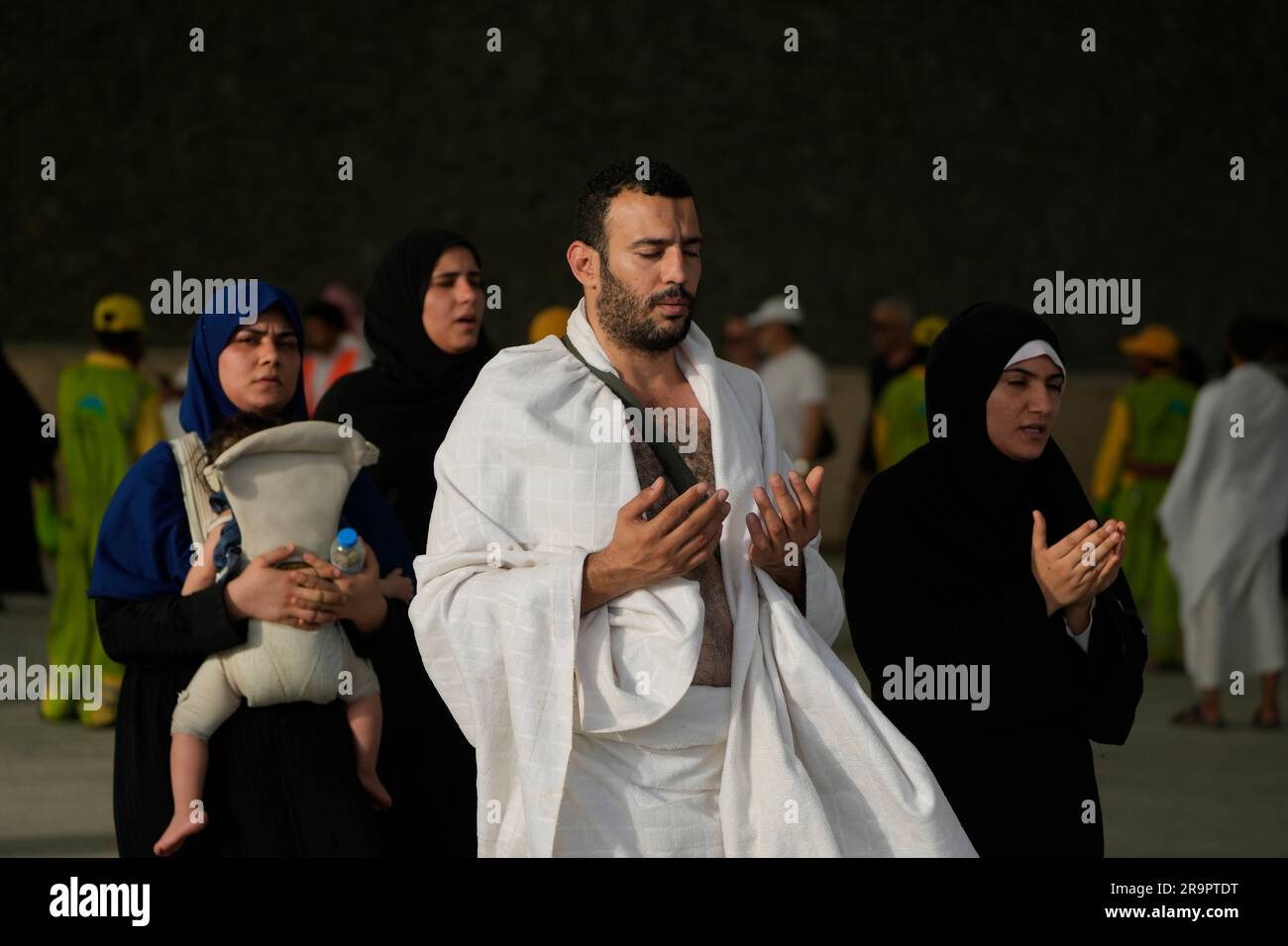 Pilgrims pray after they cast stones at a pillar in the symbolic ...