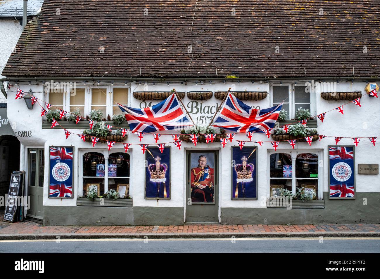 The Olde Black Horse Pub Displays Flags and Portraits Of The King On ...