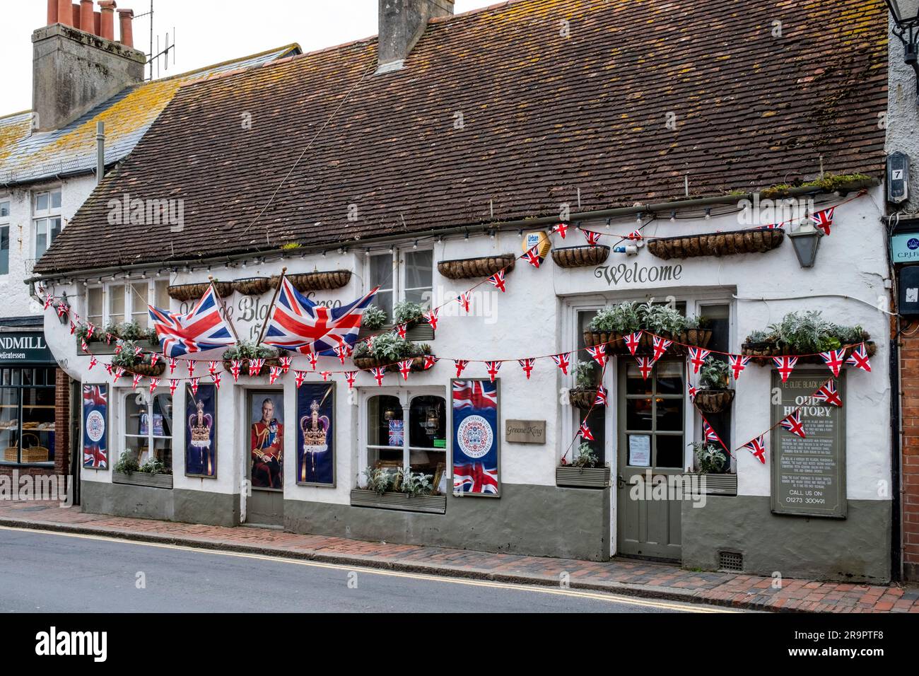 The Olde Black Horse Pub Displays Flags and Portraits Of The King On ...