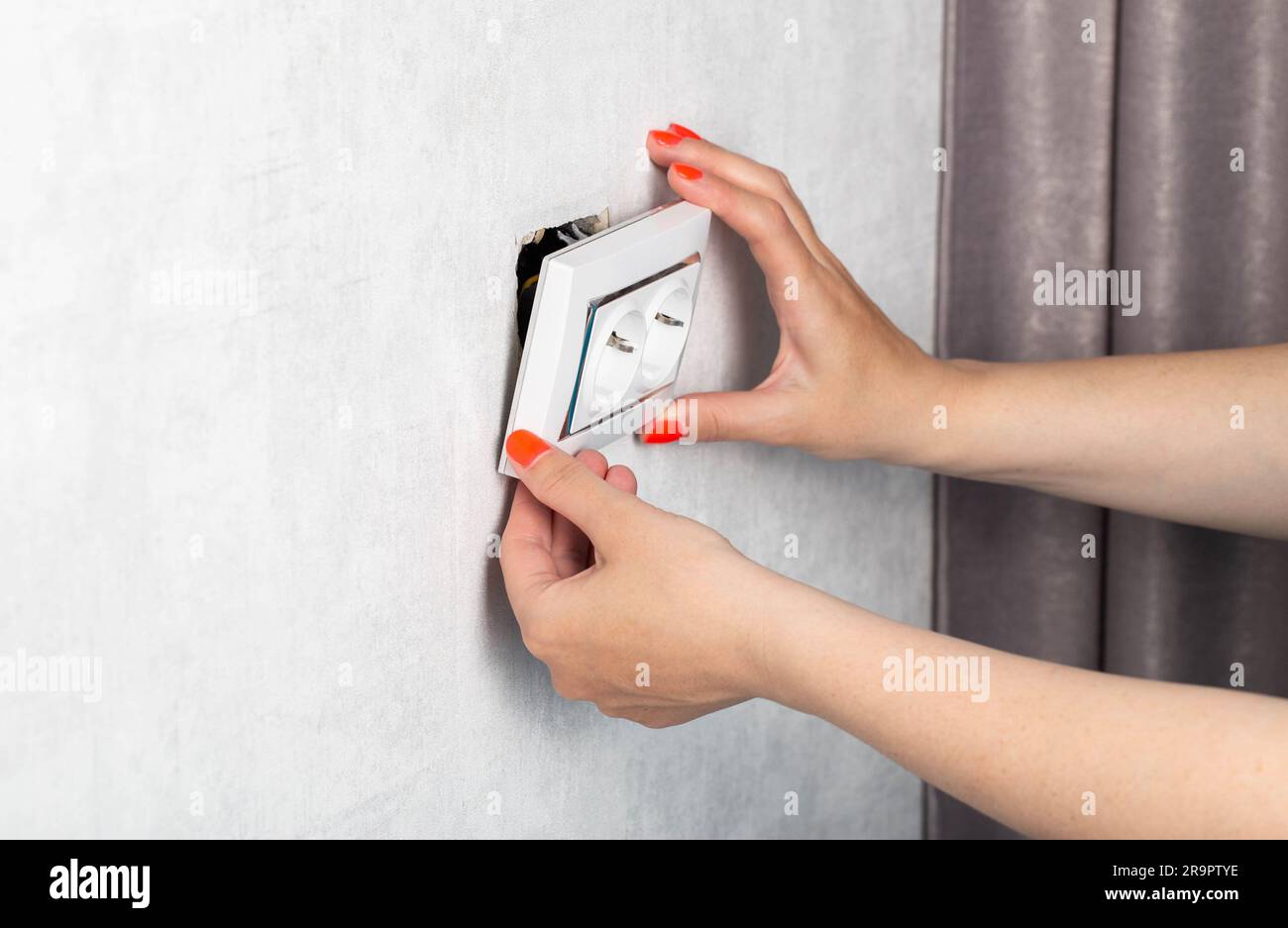 The girl is trying to insert a torn out socket from the socket due to ...