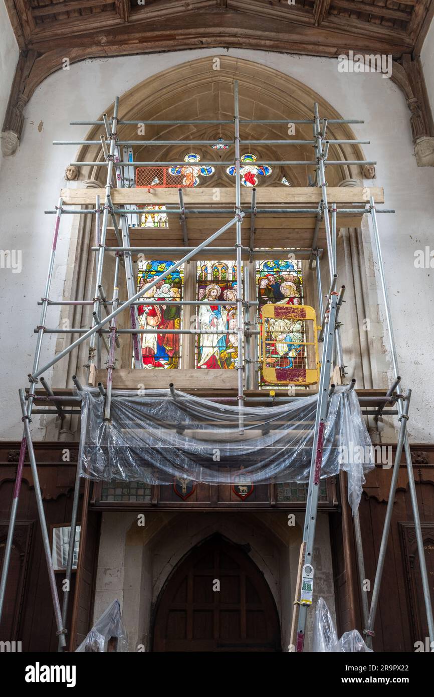 Church restoration work with scaffolding around a stained glass window ...