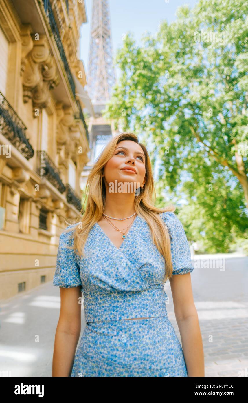 Portrait of young attractive woman fashion model posing near Eiffel ...