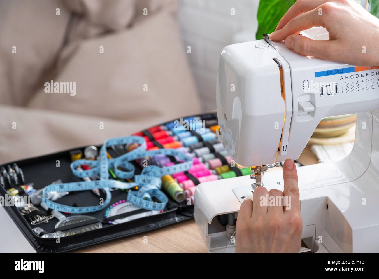 Woman hand close up sews tulle on electric sewing machine. Filling the ...