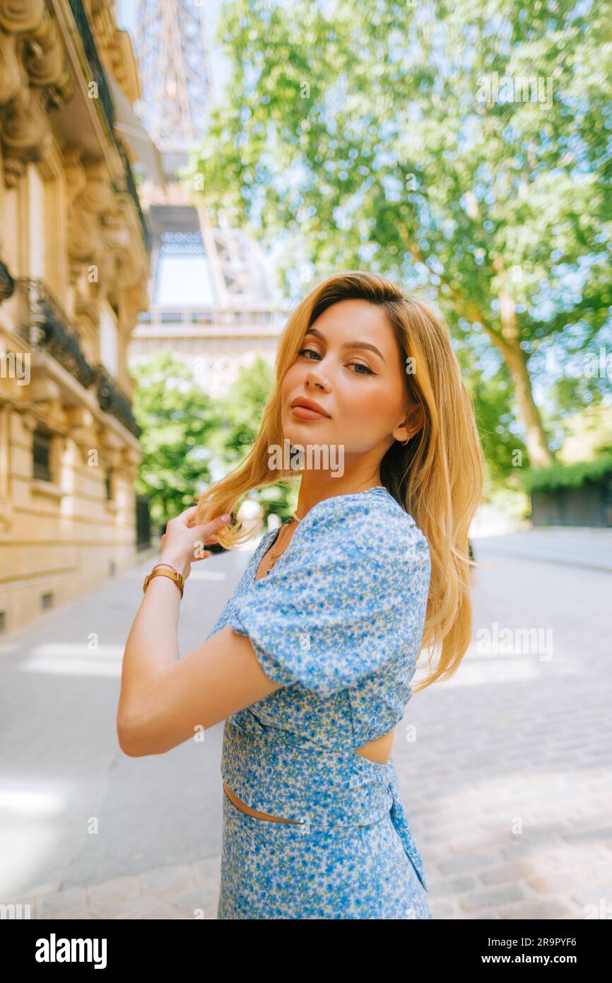 Portrait of young attractive woman fashion model posing near Eiffel ...