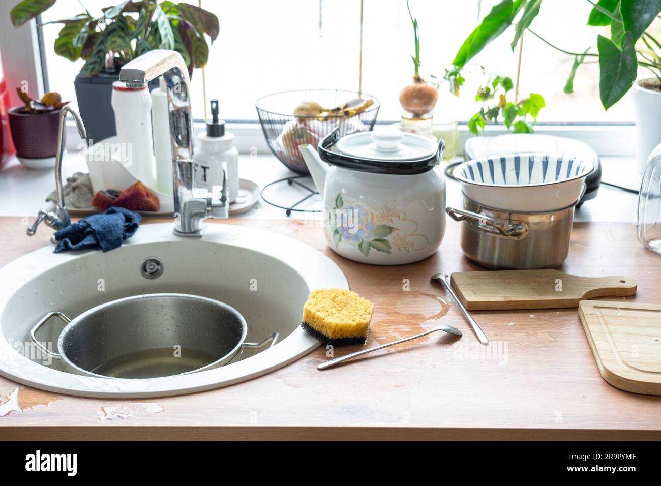 A mess in the kitchen, dirty dishes on the table, scattered things ...