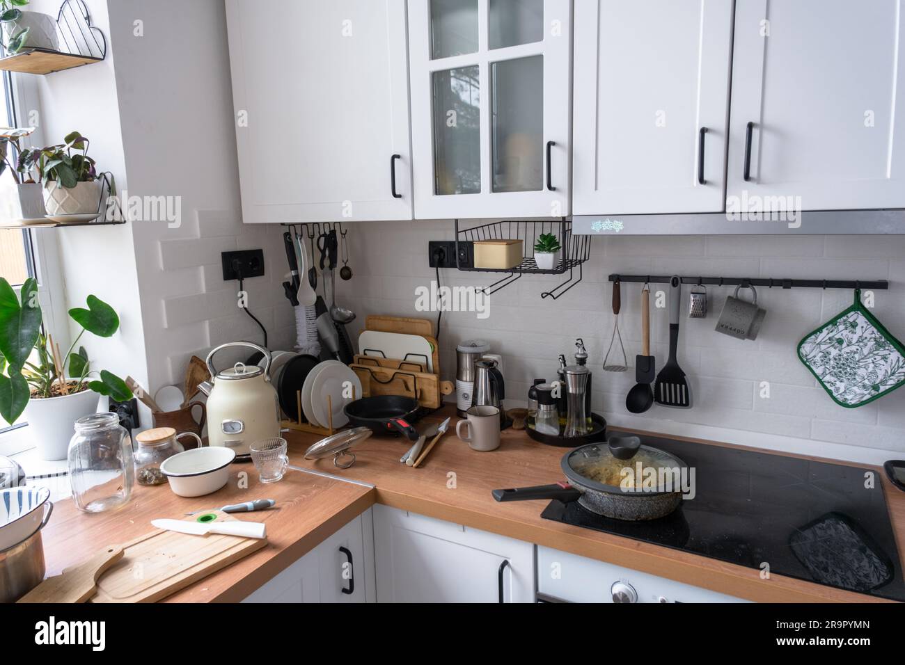 A mess in the kitchen, dirty dishes on the table, scattered things ...