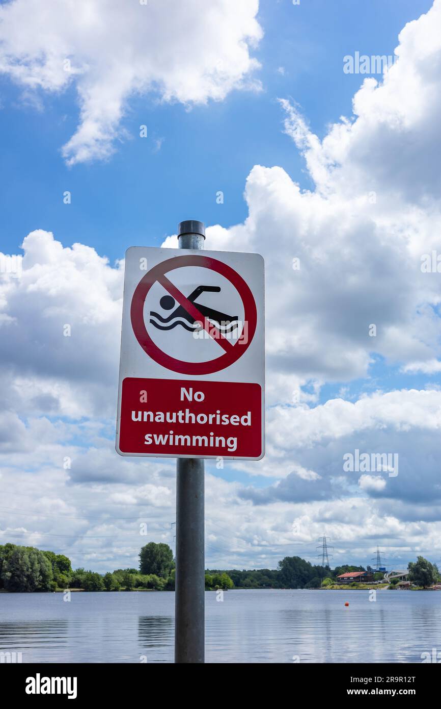 lake with caution sign and warning message; no swimming permitted Stock ...