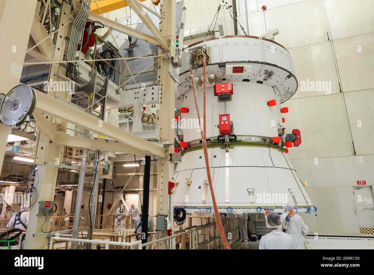 A crane moves the Artemis II European Service Module into Kennedy Space ...
