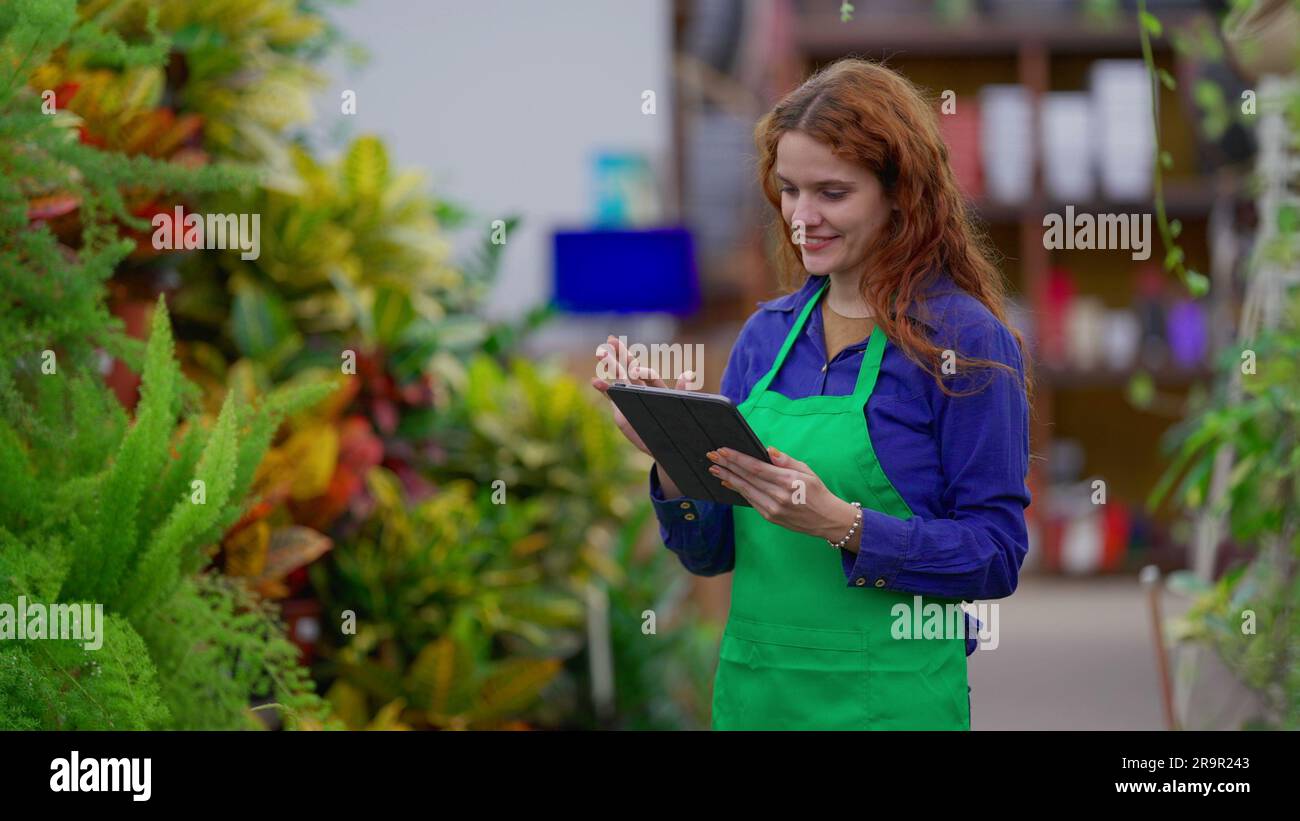 Joyful Female Manager Conducting Inventory Check in Plant Retail Store ...